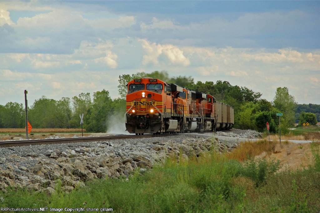 BNSF 5734 leads a empty coal train out of the storm clouds.